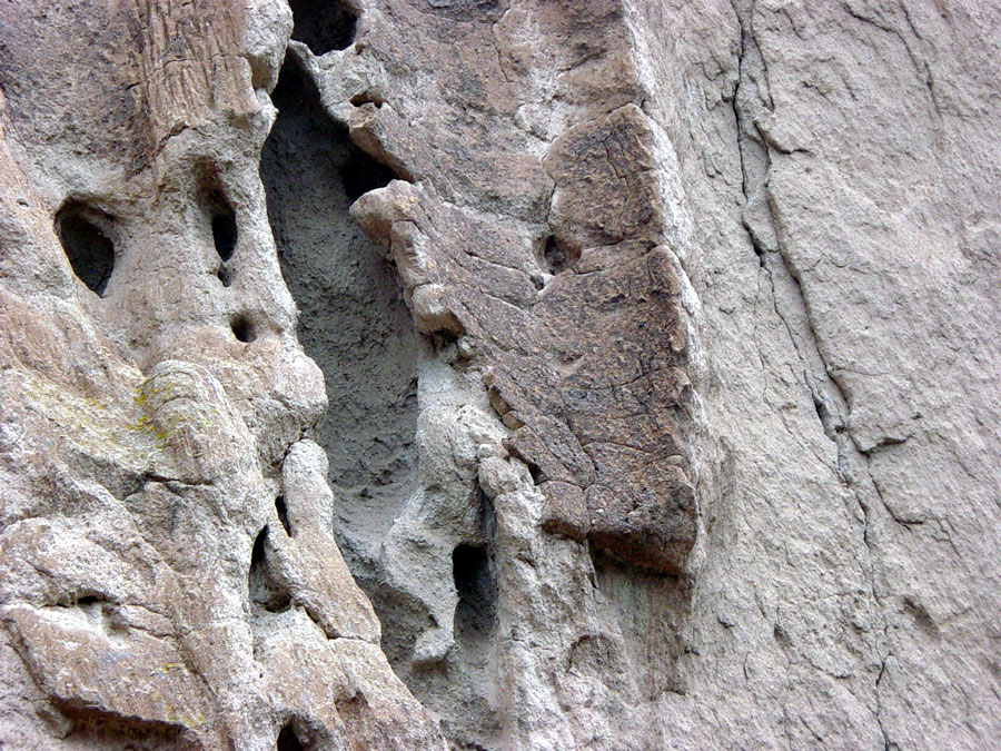 The natural holes in the cliff take all kinds of interesting shapes and ...