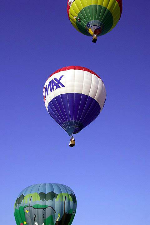 Three balloons lift off into the beautiful blue sky. | Pics4Learning