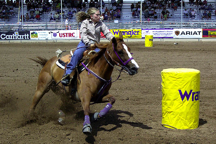 A contestant makes her way around the barrel racing course. | Pics4Learning