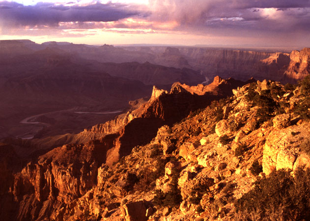 Rain clouds tease the desert as the sun sets at Lipan Point ...